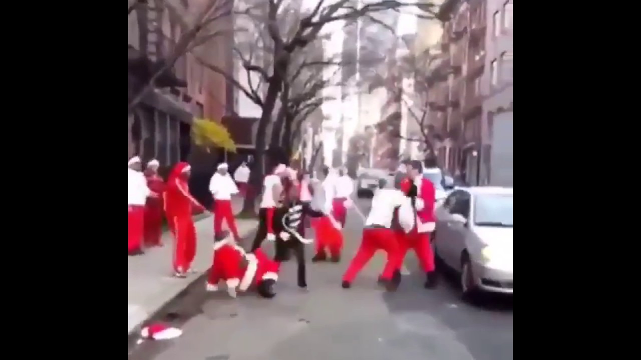 Group of santas start a fight on the street while christmas music plays ...