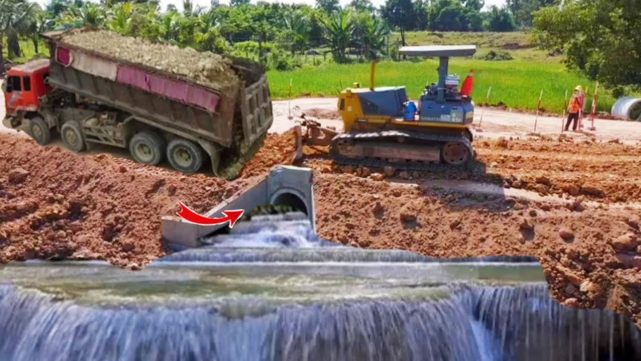 Construction of a road to a flowing waterway area. By a dozer operator ...
