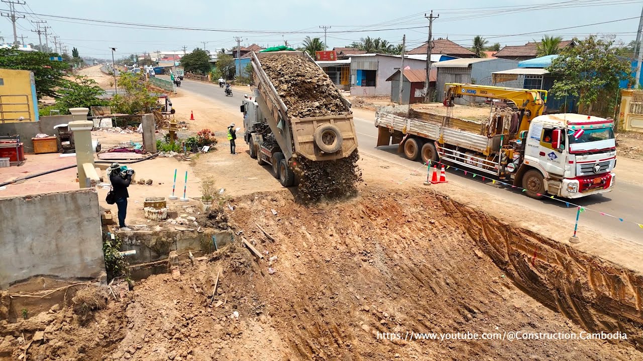 First dirt perfect Dump Truck unloading with Bulldozer pushing stone ...