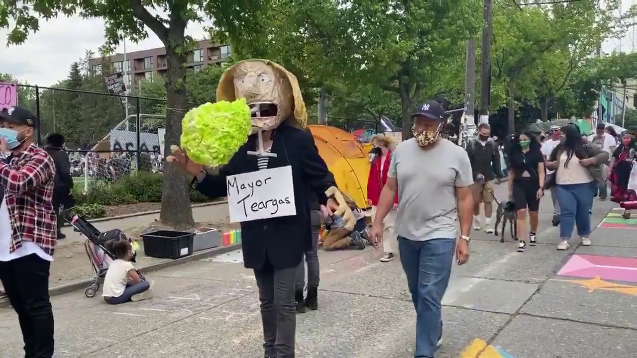 “Mayor Teargas” (depicting Seattle Mayor Jenny Durkan) is walking ...