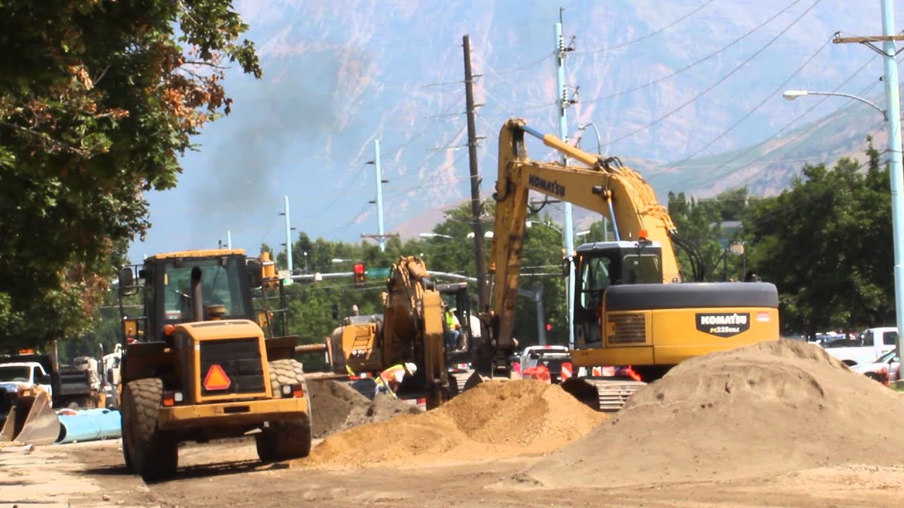 Excavators and loader working on a road construction site - YouTube