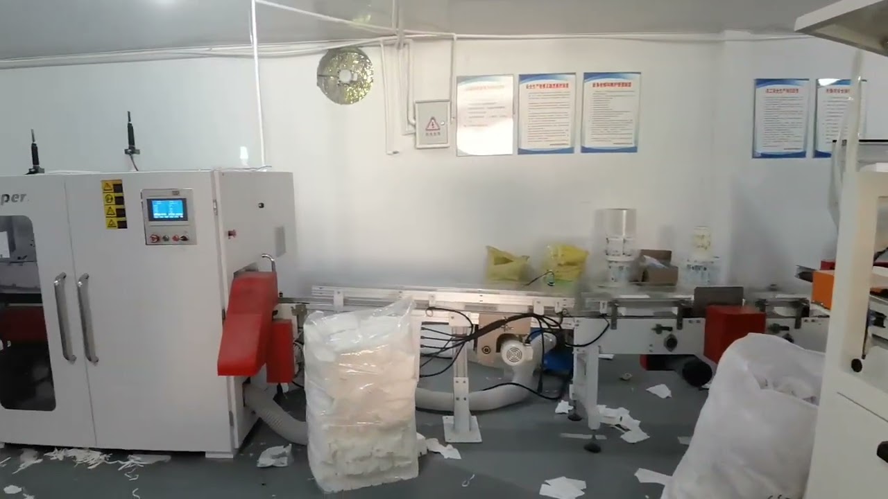 A tissue paper production line includes tissue paper cutting and ...