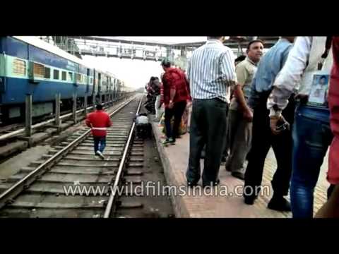 Man falls off train platform in India, with incoming train - YouTube