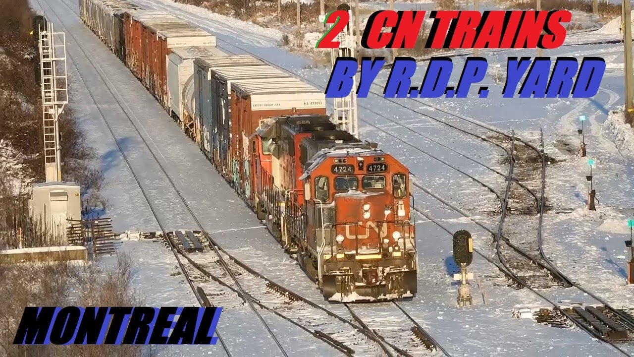 12 6 23 EPIC 2 CN TRAINS CROSS PATHS IN SNOW BY MONTREAL R.D.P. YARD ...