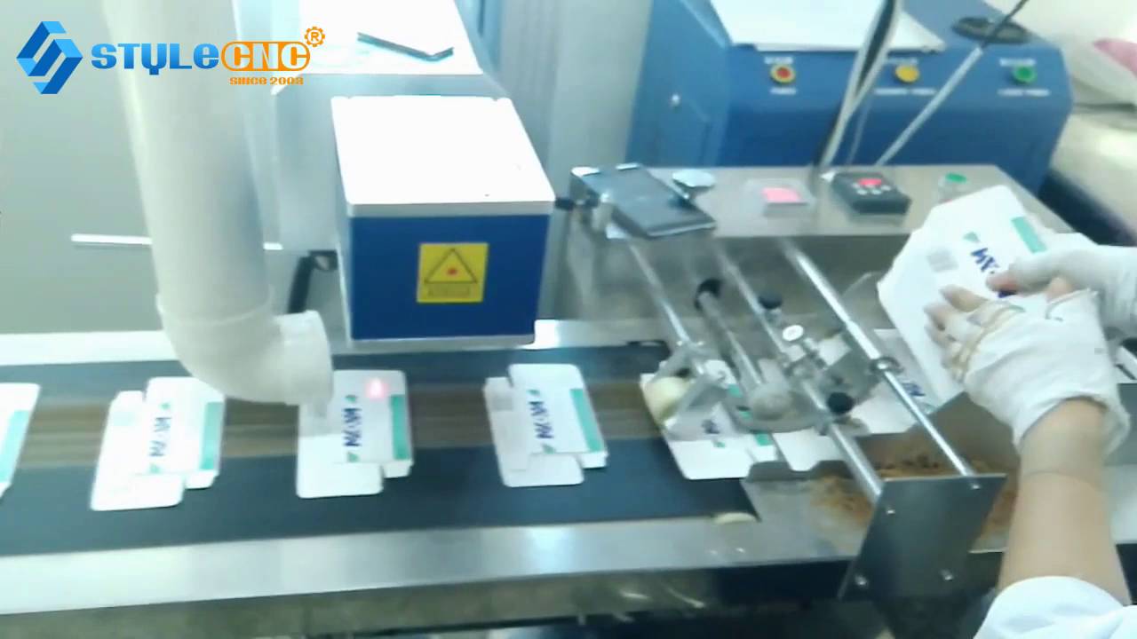 Online flying laser marking machine marking on medicinal packing box ...
