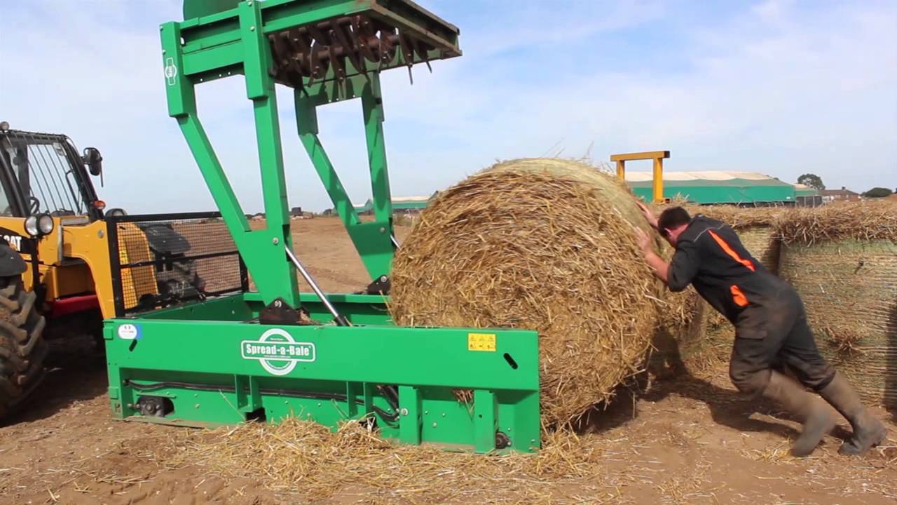 07 Loading A Round Bale Into A Maxi Machine Manually - YouTube