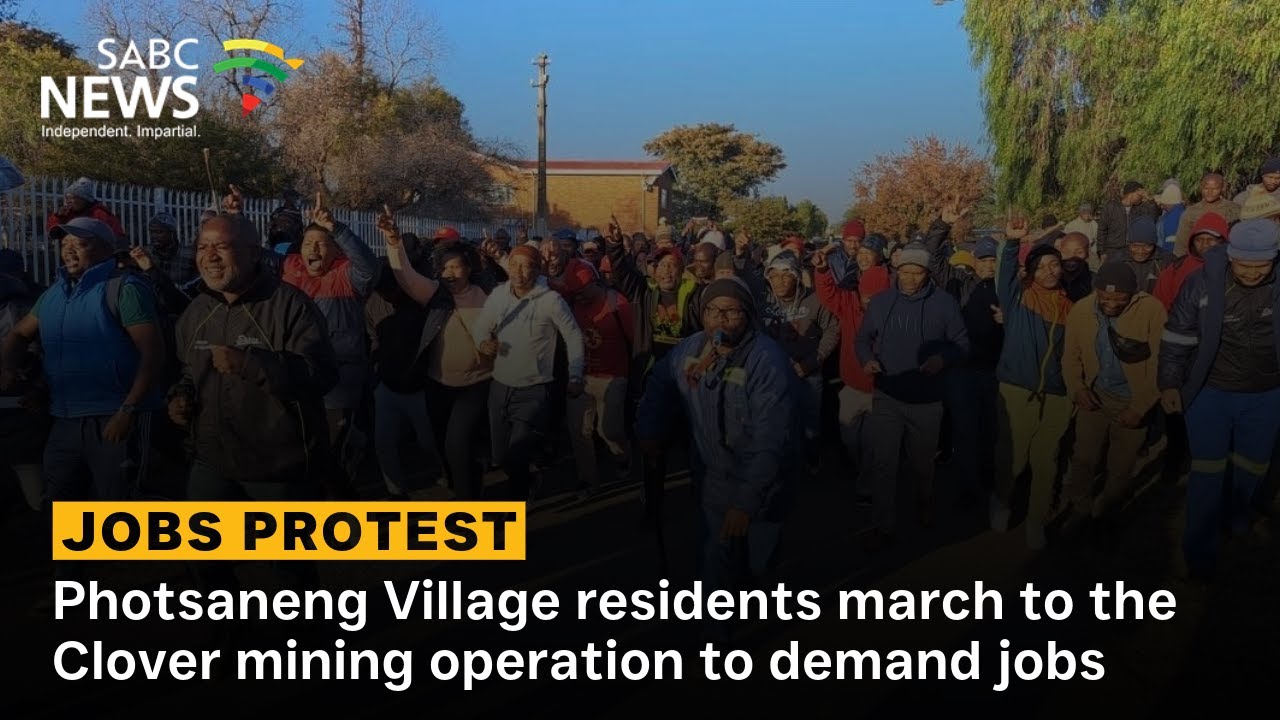 Photsaneng Village residents march to the Clover mining operation to ...
