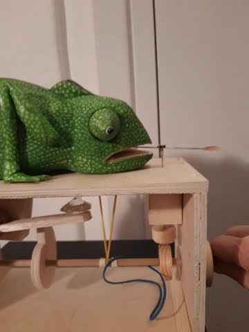 Chameleon 2 , wooden automata . He doesn`t see the insect right under ...