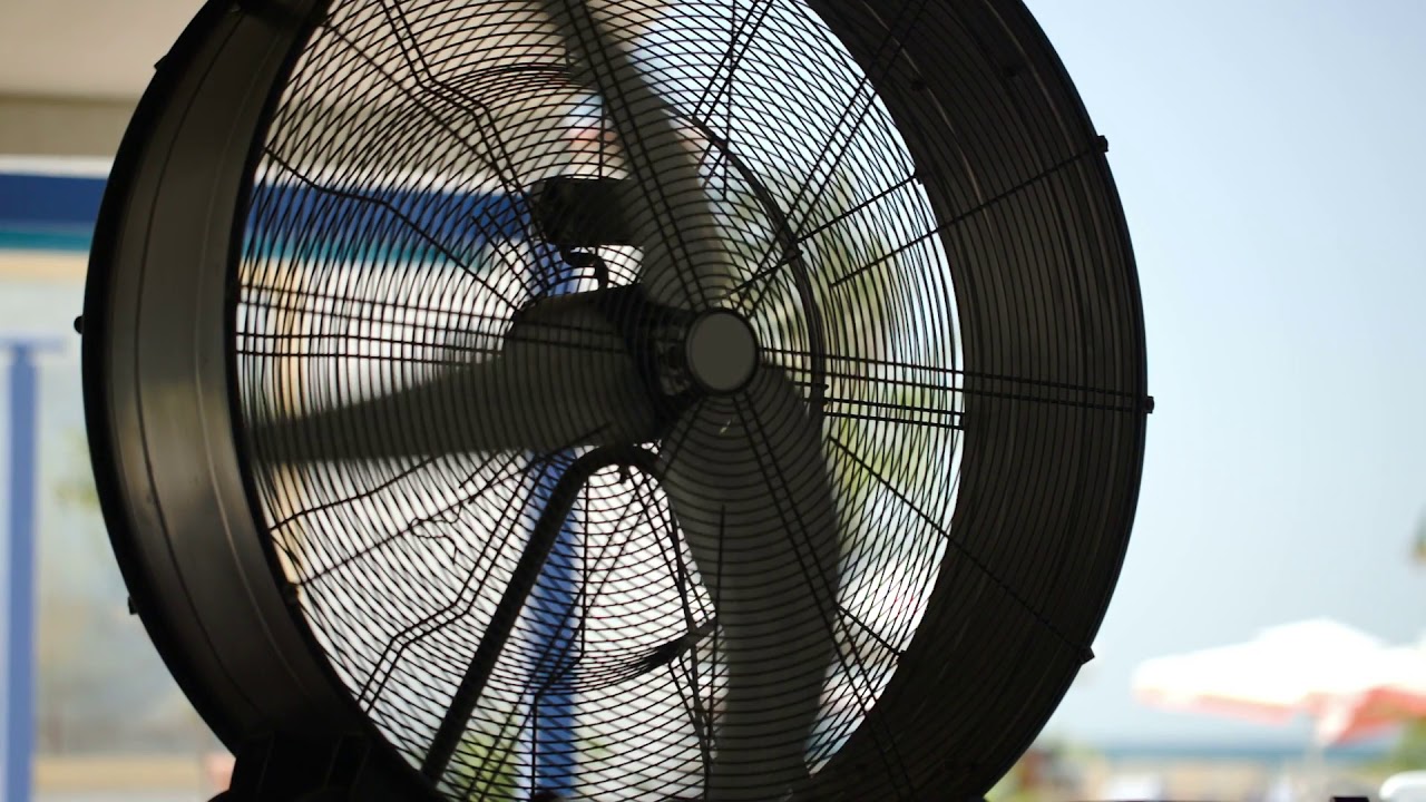 close up shot of a big working ventilator with its blades rotating ...