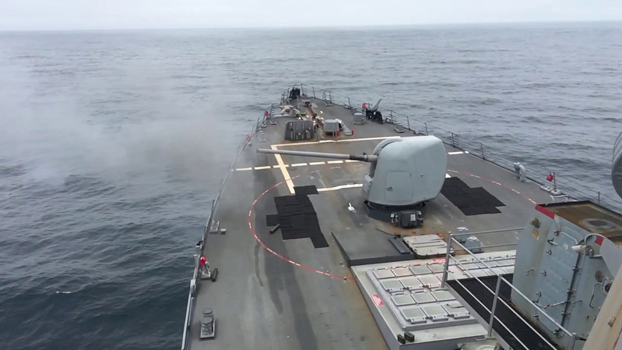 Slow motion video of a 5-inch gun firing aboard USS Oscar Austin during ...