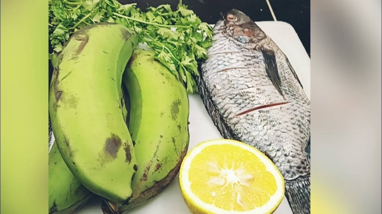 Healthy food//three green bananas/Fresh tilapia fish/half orange ...