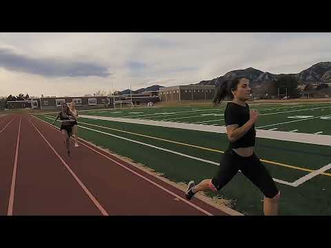 Girl runner in full black clothing hocks spit during training sesh