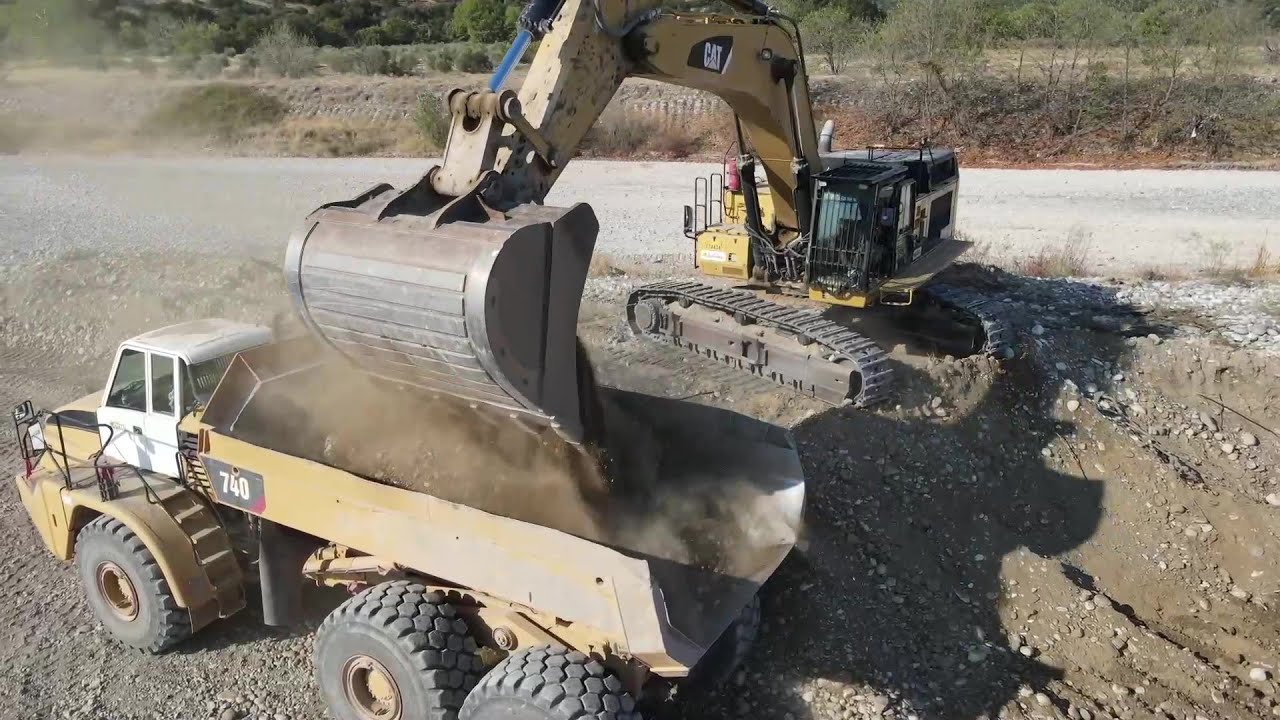 Caterpillar 374D Excavator Loading Caterpillar 740 Articulated Dump ...