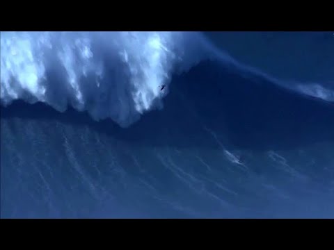 Surfer breaks world record by riding 80-foot wave - YouTube