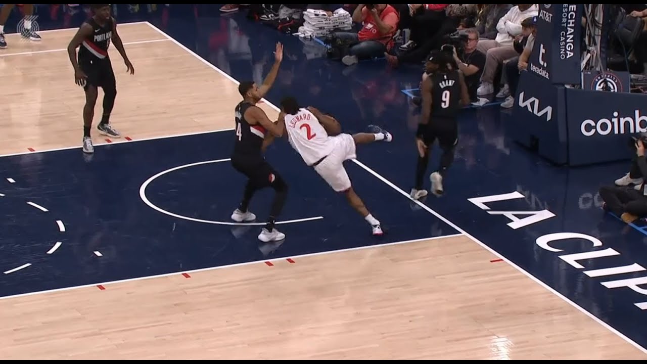 Kawhi Leonard desperately jumps forward while falling down in order to ...