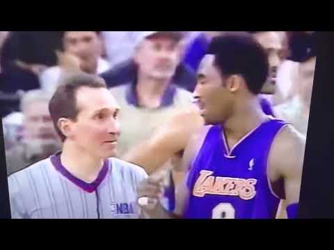 Kobe Bryant and Vlade Divac wrestle for the loose ball and then have words face to face (2001).