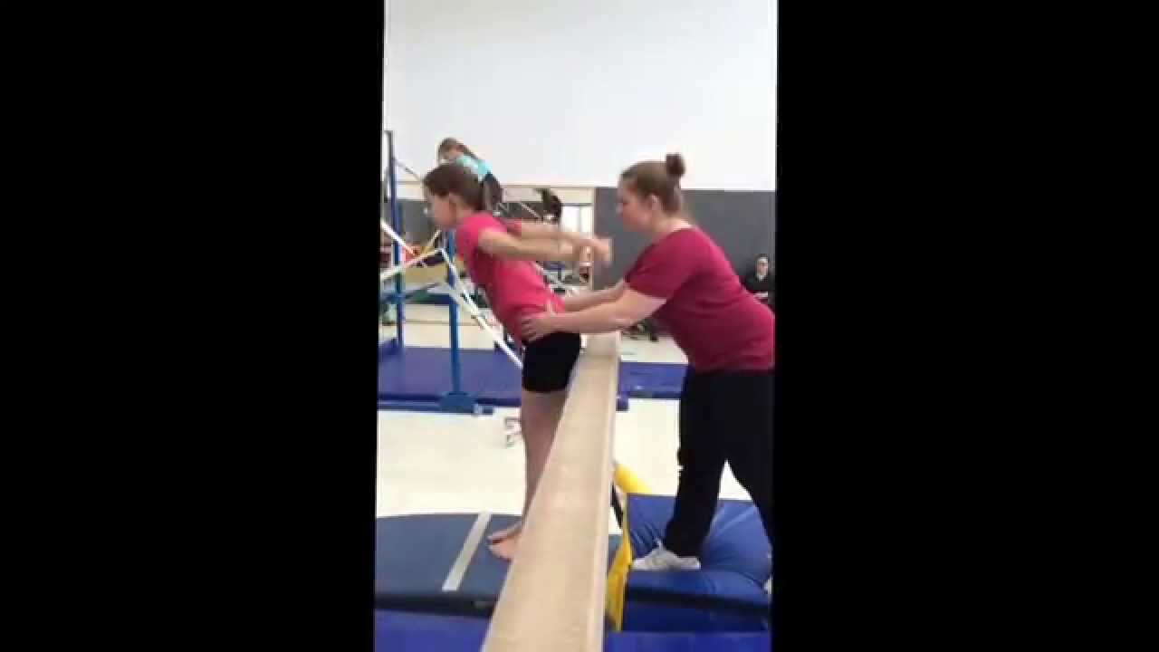 BB mount: jump bwd through straddle position over the beam to front ...