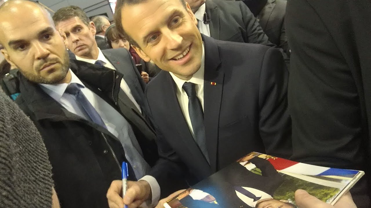 President Emmanuel Macron signing autographs in Paris - YouTube