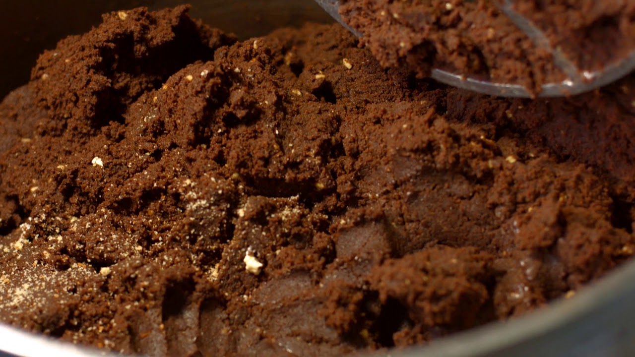 pile of dark brown powder machine pressing brown powder processing ...