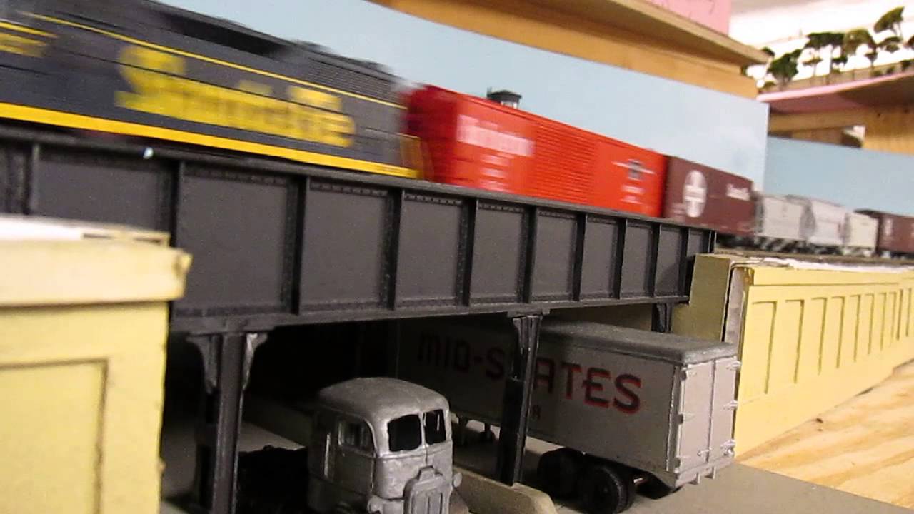 A 1970's era Santa Fe freight train speeds across a city viaduct. - YouTube