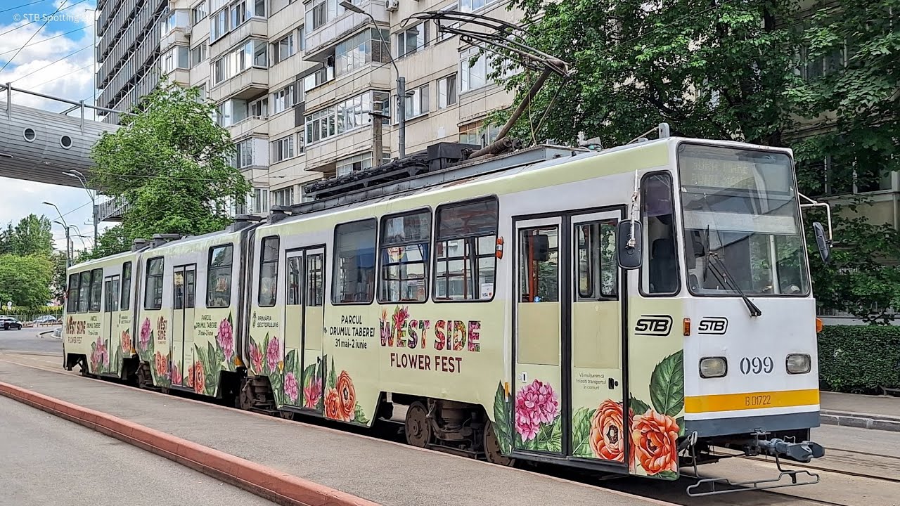 Tramvaiul V3A-93 099, colantat, parasind statia "Piata Danny Huwé" pe ...