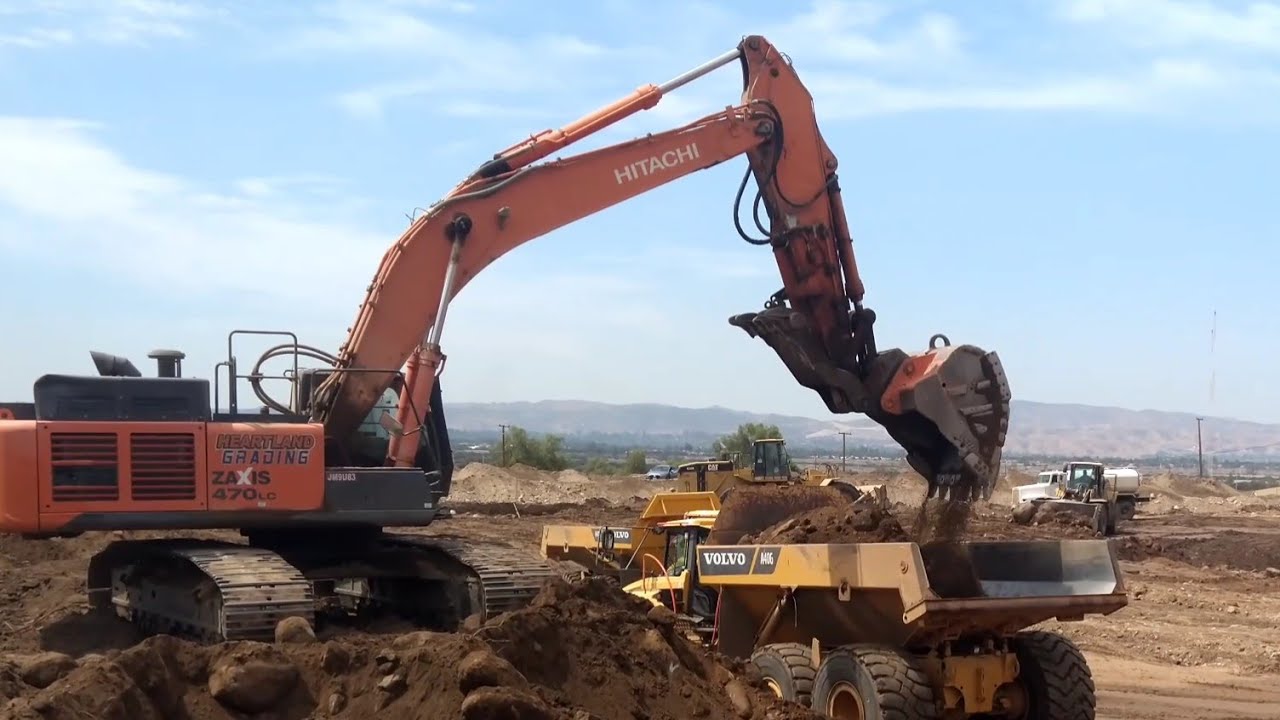 HITACHI 470LC Excavator loading VOLVO A40G articulated dump trucks ...