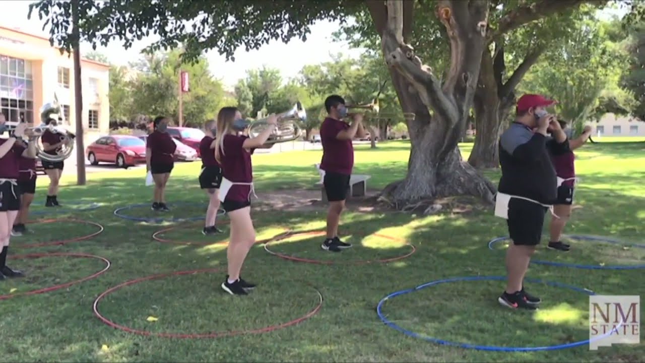 NMSU marching band creates masks with opening for instruments - YouTube