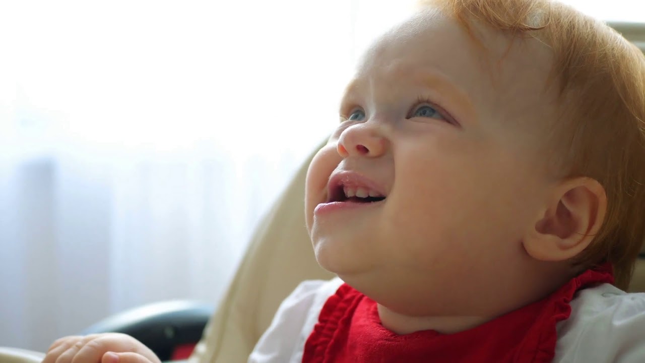 baby eating puree with spoon close up of infant baby face eat baby ...
