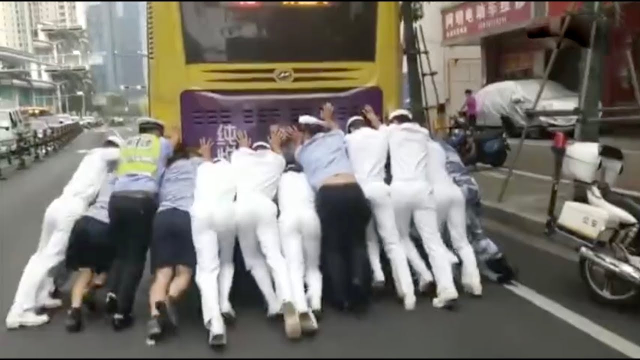 Police and navy officers push bus with bare hands - YouTube