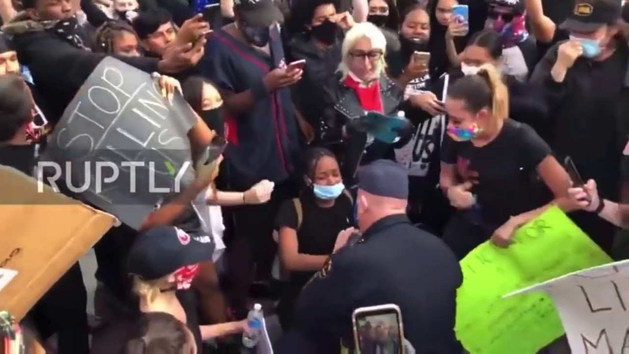 USA: Police officer kneels to hug Protester at California rally - YouTube