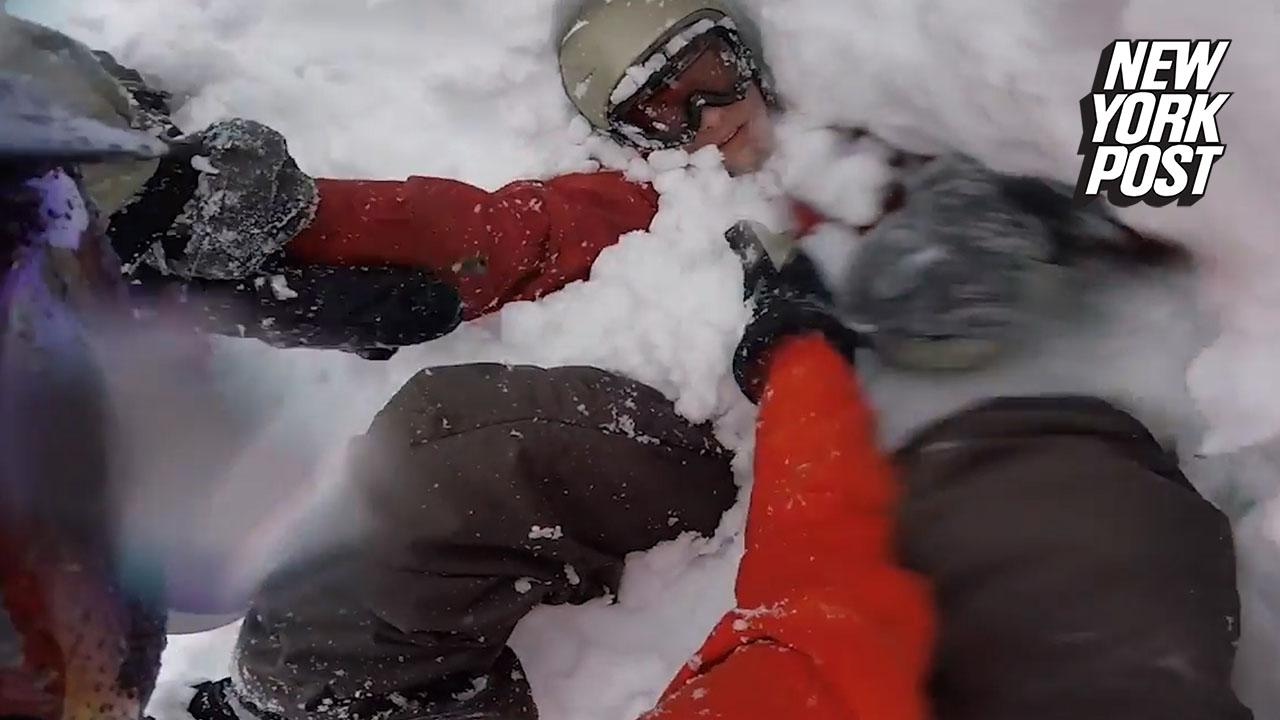 Snowboarder buried head-first in snow after falling off cliff - YouTube