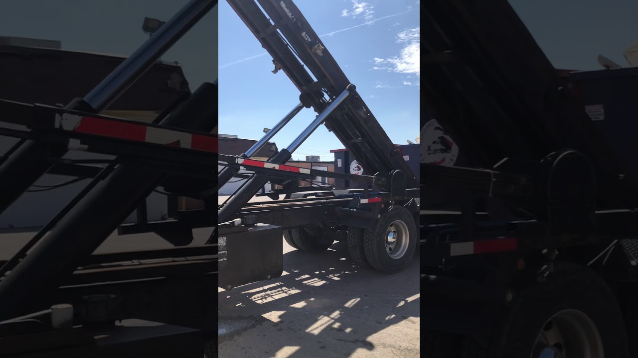 Roll off Driver placing a manual tarp - YouTube