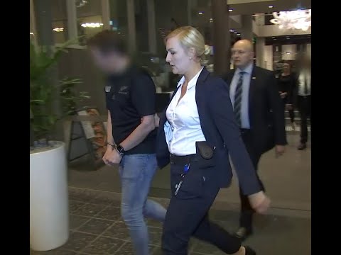 Doctor handcuffed and arrested by policewoman.
