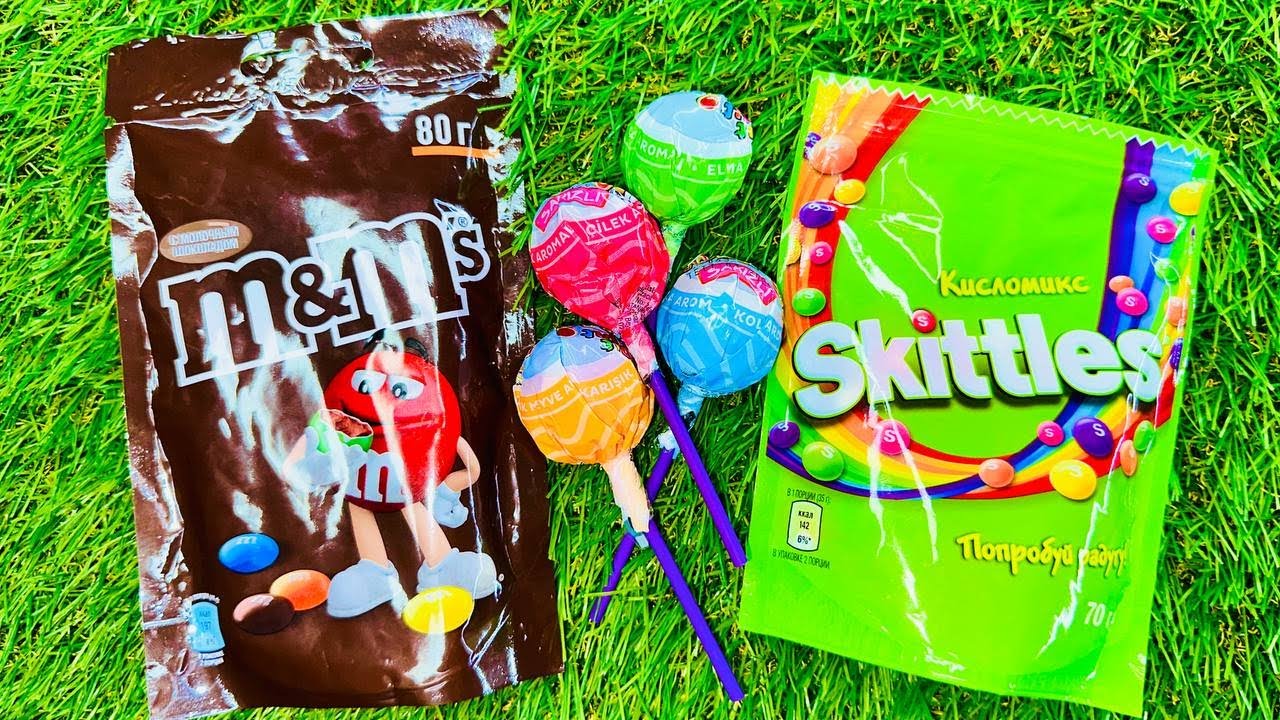 Learn colors | Skittles and M&m's against bright lollipops | Unpacking ...