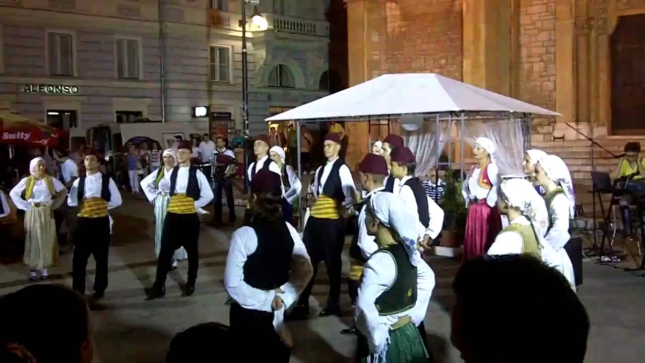 Traditional Bosnian dance by performers in open square in old town ...