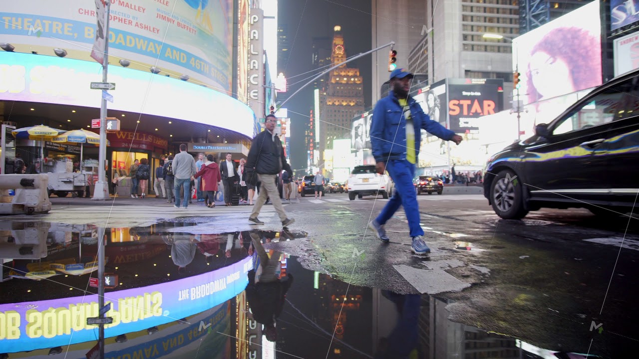 Times Square Lights reflecting in puddle after rain in New York City at ...