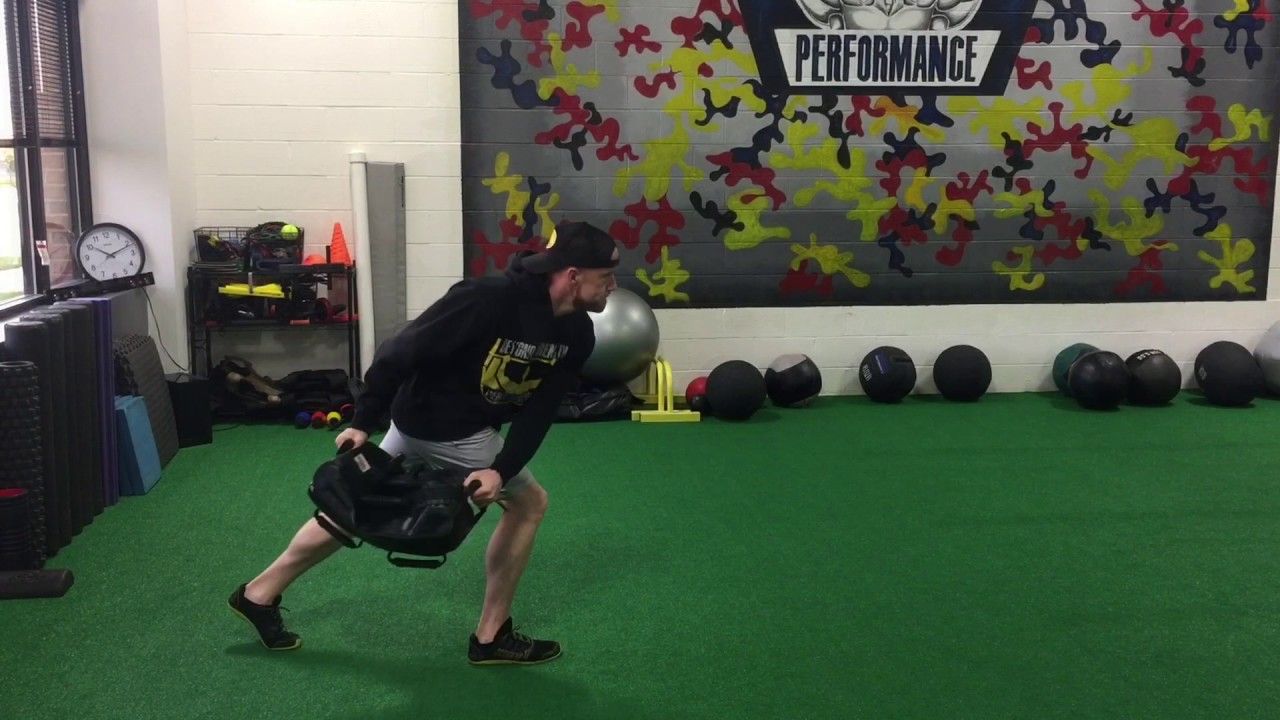 Split Stance Anti-Rotational Sandbag Swing - YouTube