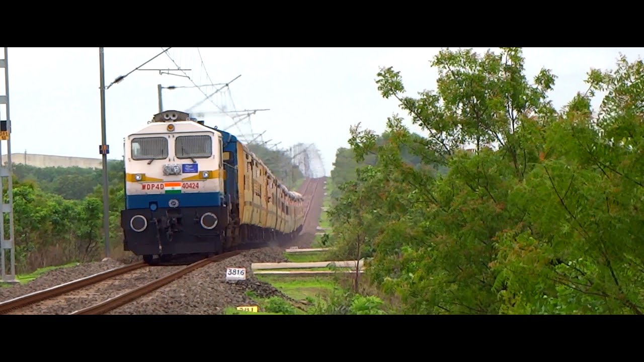 The train is coming from behind the hill. - YouTube