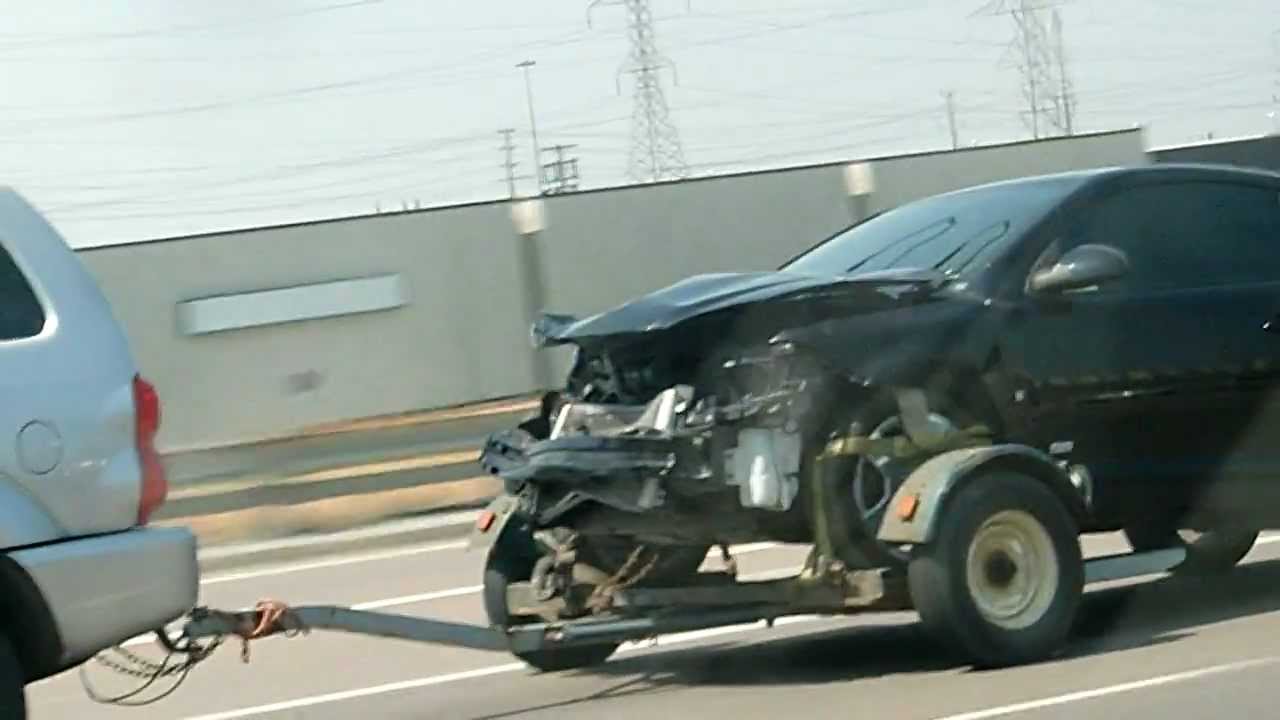 Wrecked 2009 Chevy Cobalt being towed - YouTube