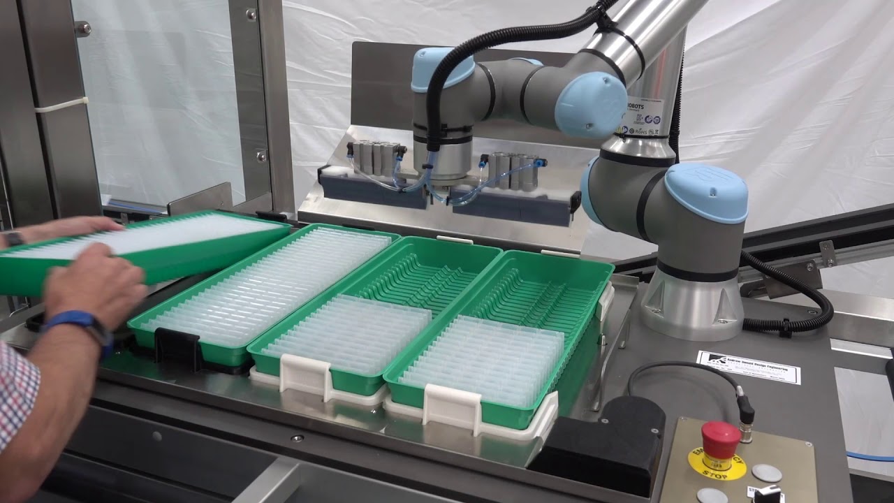 UR5 collaborative robot loading parts onto a conveyor - YouTube