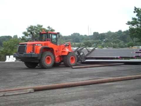 Wheel Loader Loading Pipe with a Grapple Fork - YouTube