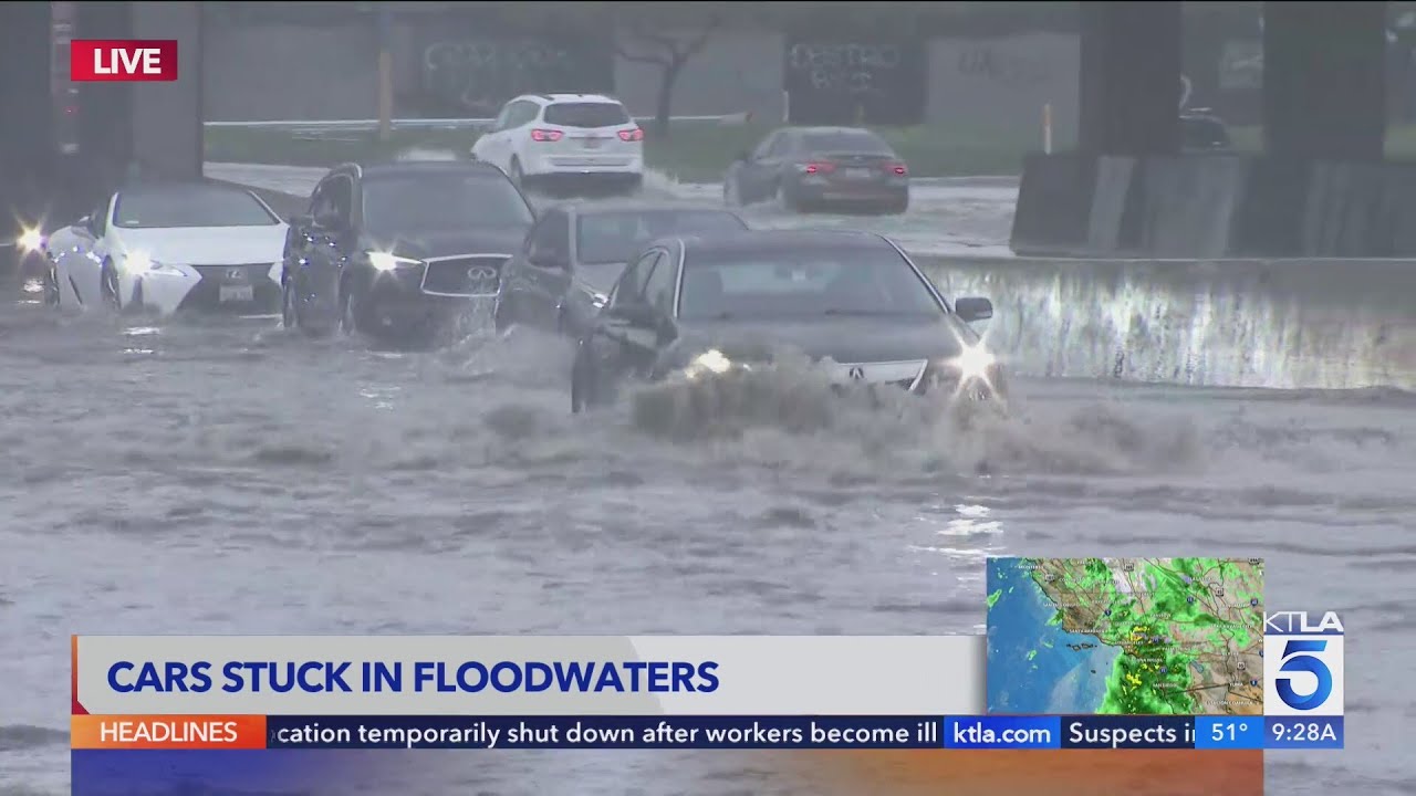 Rainwater floods 710 Freeway as determined motorists forge on - YouTube
