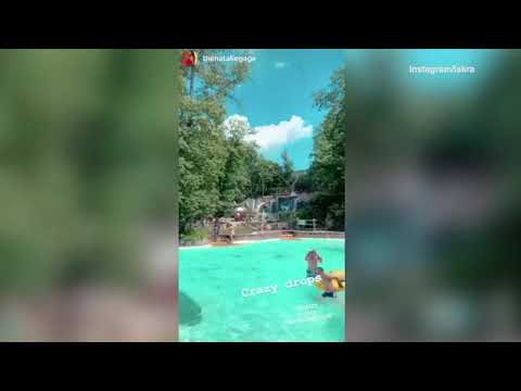 Iskra Lawrence screams on waterslide in neon pink swimsuit