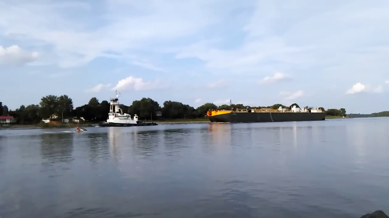 Barge, tug boat and jet ski ! - YouTube