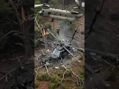 This Helicopter Has Crashed In The Jungle And Is Being Picked Up By A Chinook Helicopter.