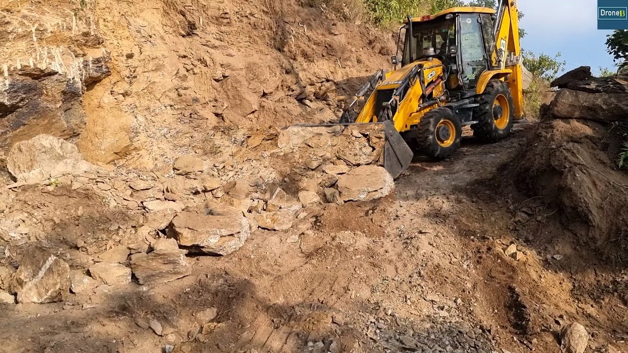 Cutting and Leveling Dirt on Narrow Hillside Road with Jcb Backhoe ...