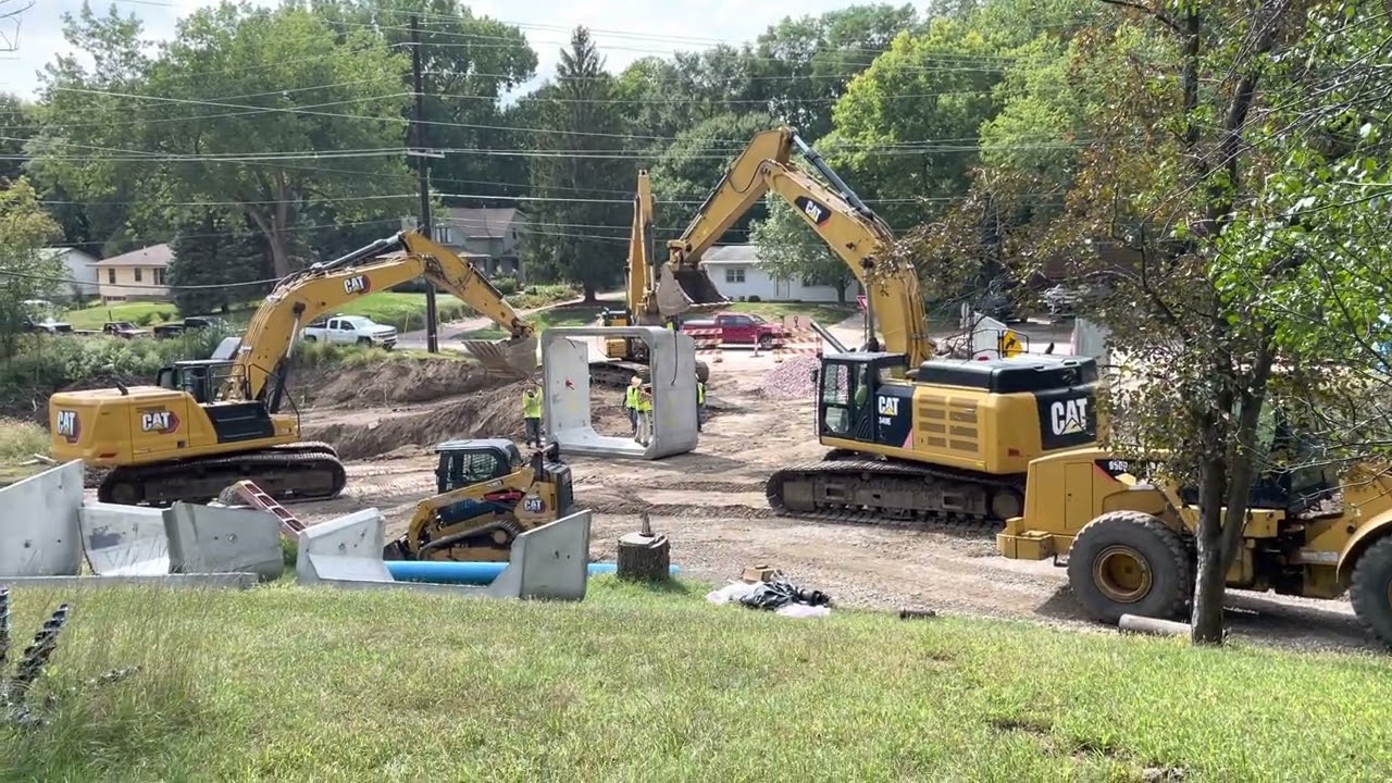 2 Excavators Moving First Large Box Culvert Section into Position. Road ...