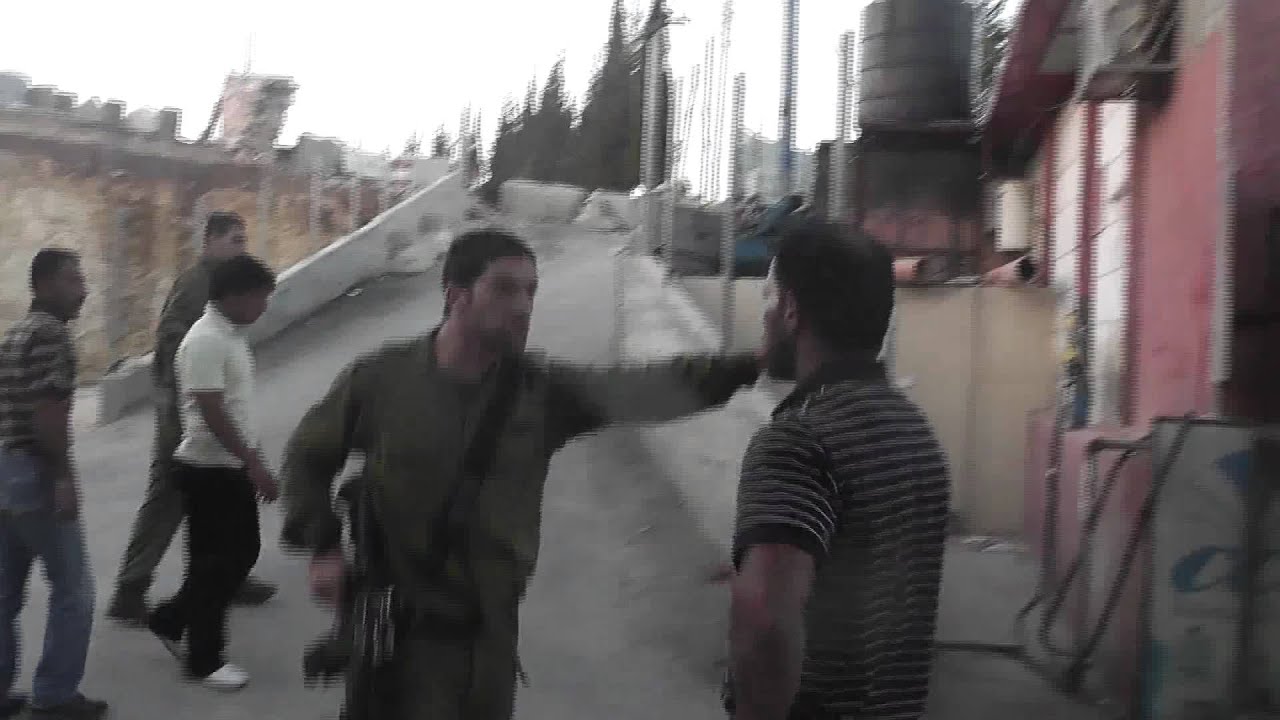 IDF coward points loaded weapon into face of an innocent Palestinian ...