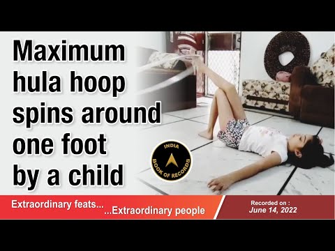 Maximum hula hoop spins around one foot by a child