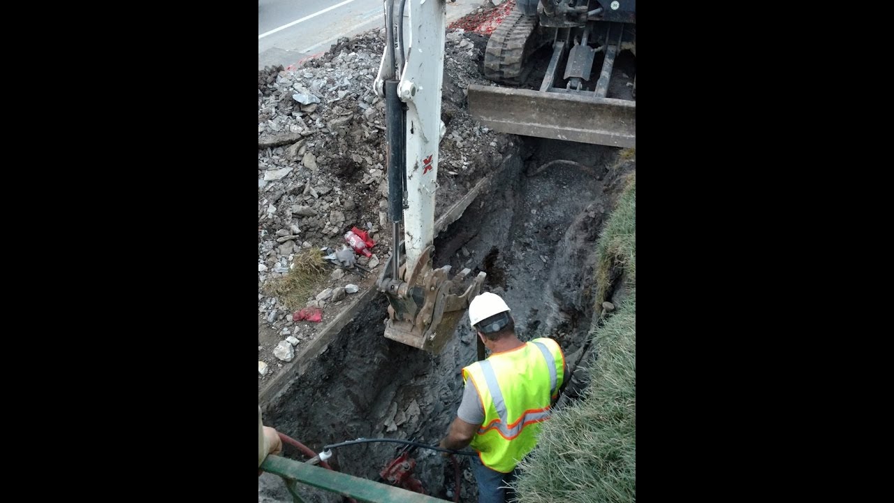 Crew filling in the 7 foot deep hole they made in the front yard. - YouTube